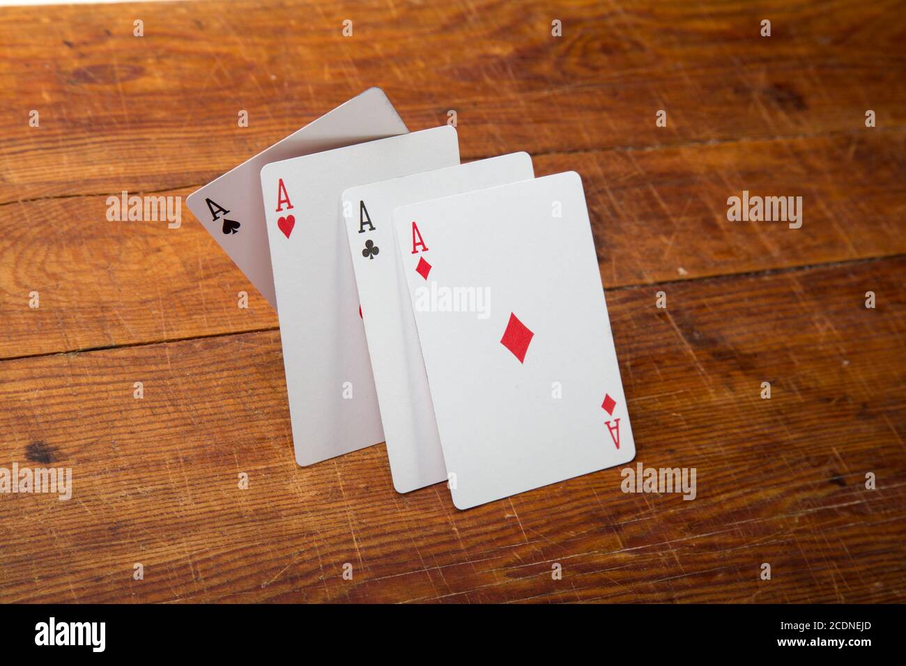 Aces on a wood background Stock Photo - Alamy