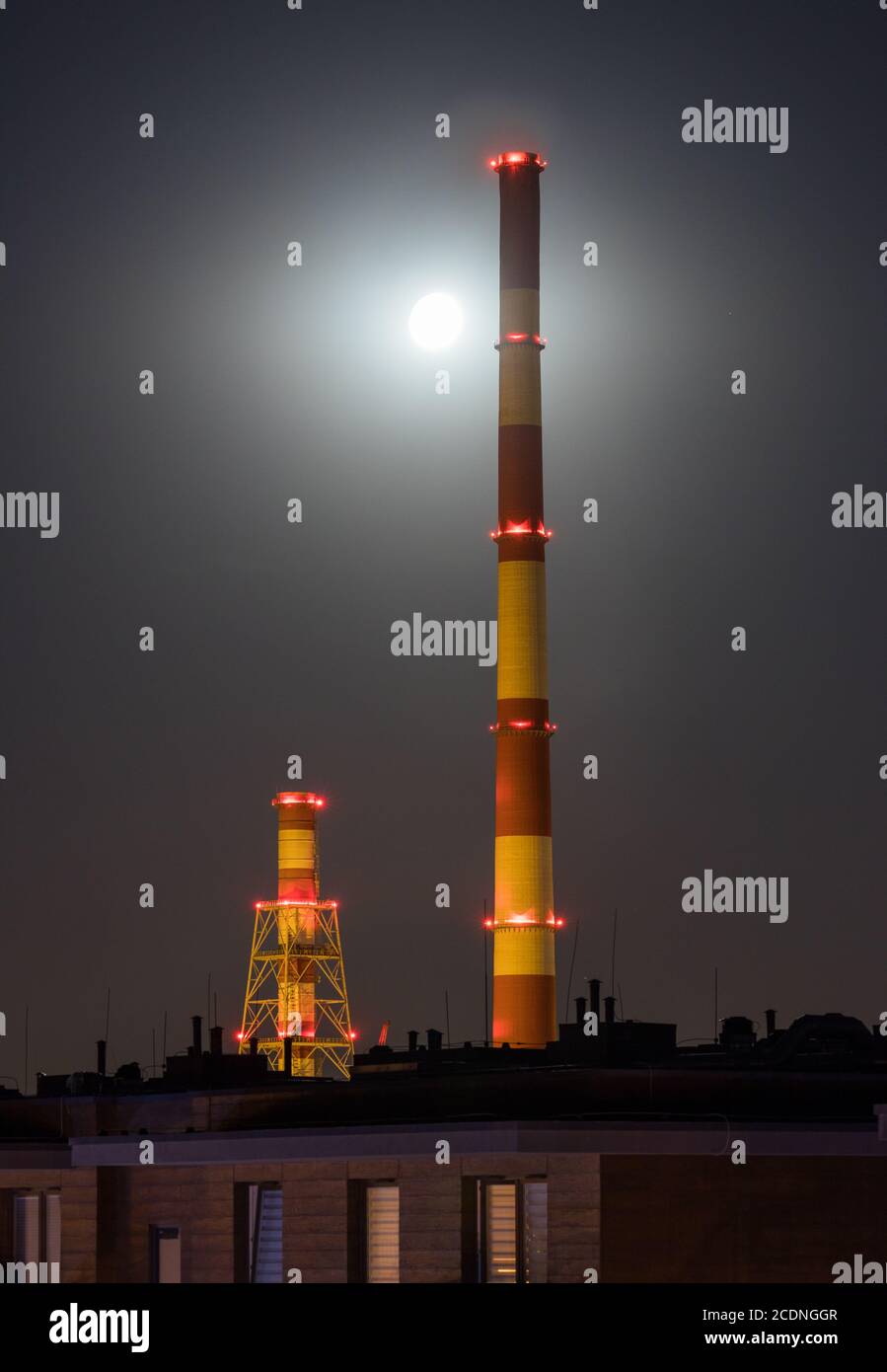 Huge industrial chimneys lit by a full moon Stock Photo - Alamy