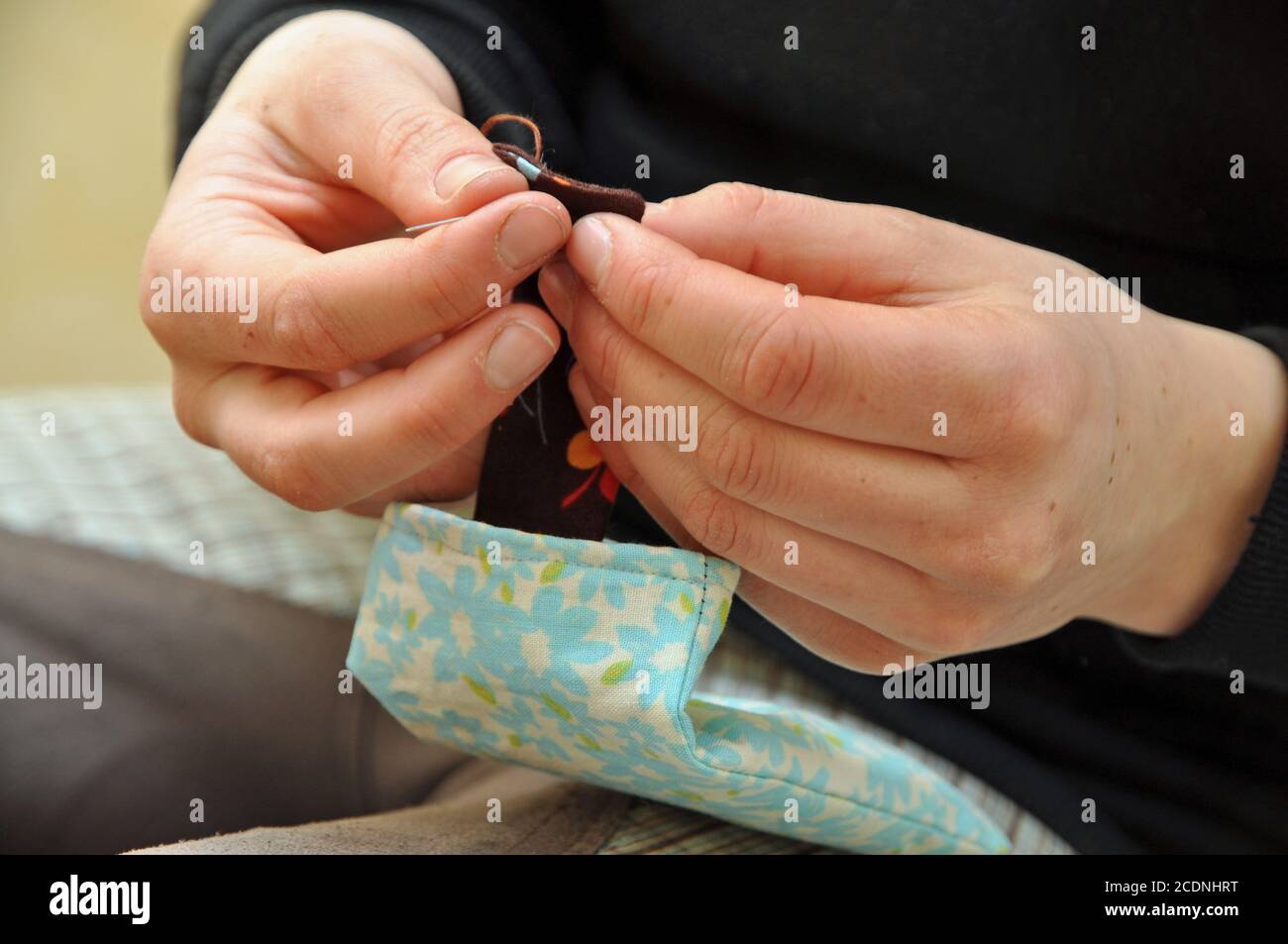 Hands with sewing needle Stock Photo - Alamy