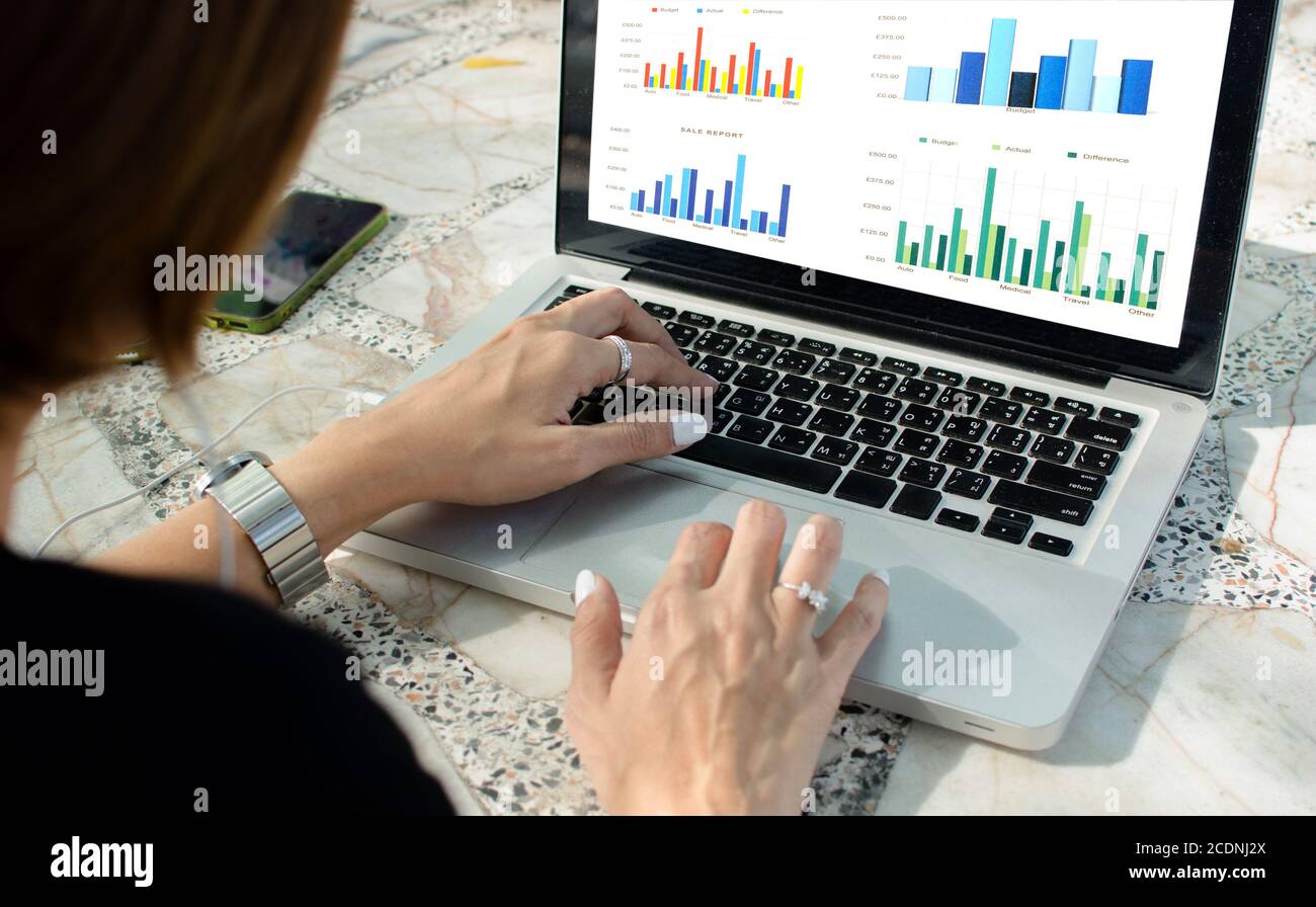 Businessman using laptop graphs hi-res stock photography and images - Alamy