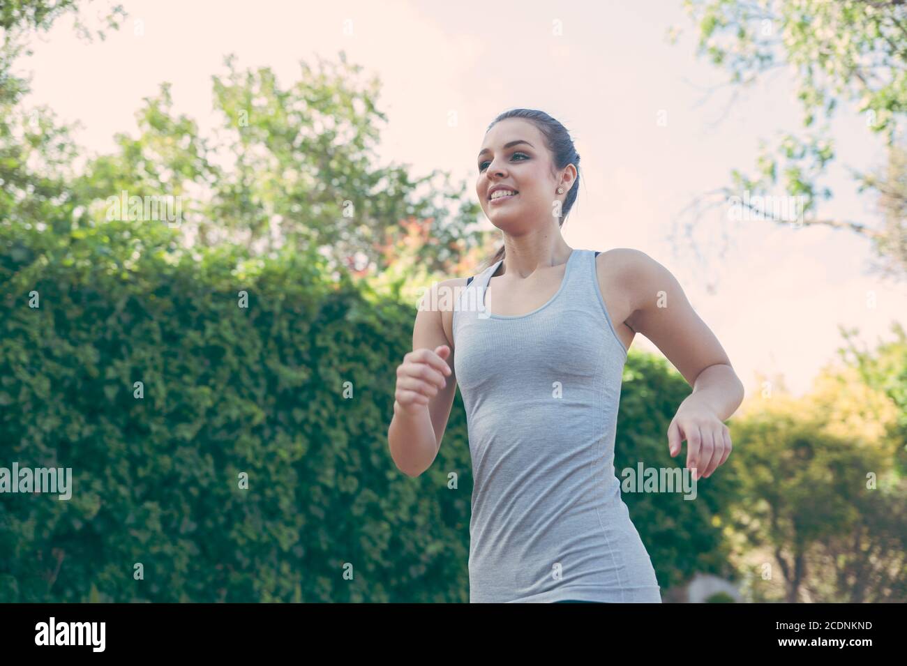 Young woman running through street hi-res stock photography and images ...