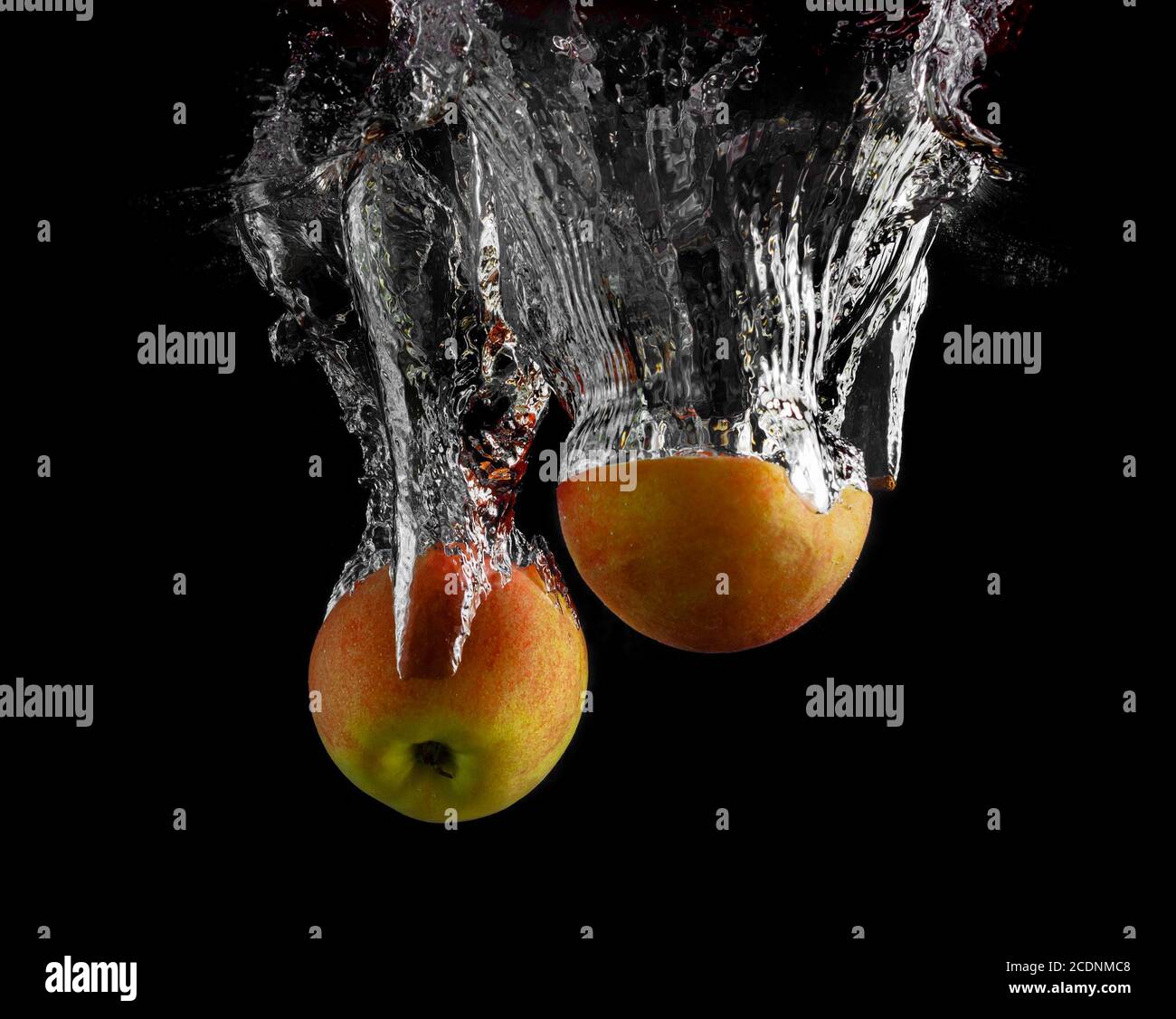 Apples falling into the water Stock Photo - Alamy