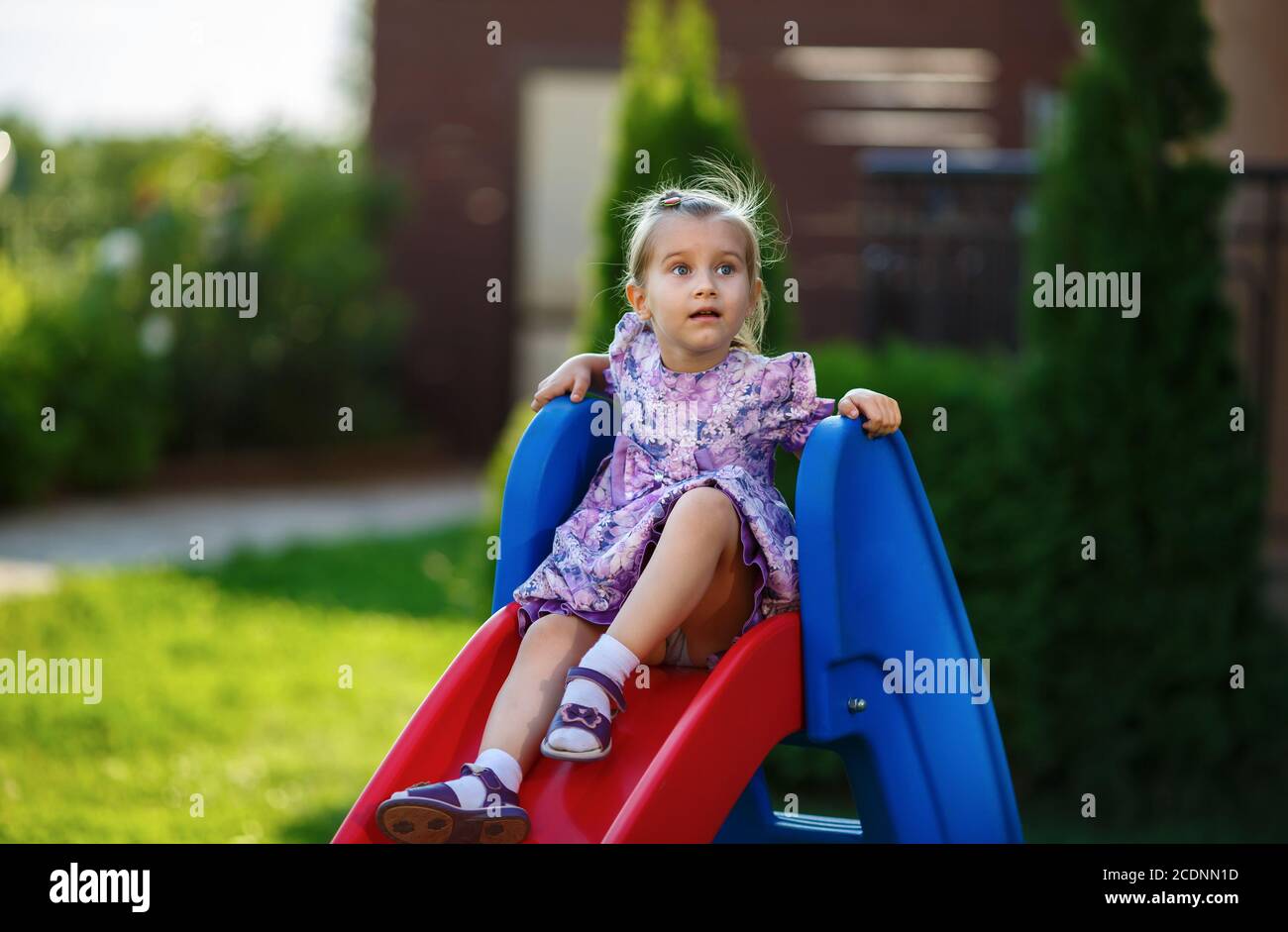 Child on slide Stock Photo - Alamy