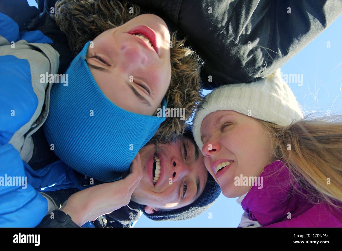 Group of three smiling young people Stock Photo - Alamy