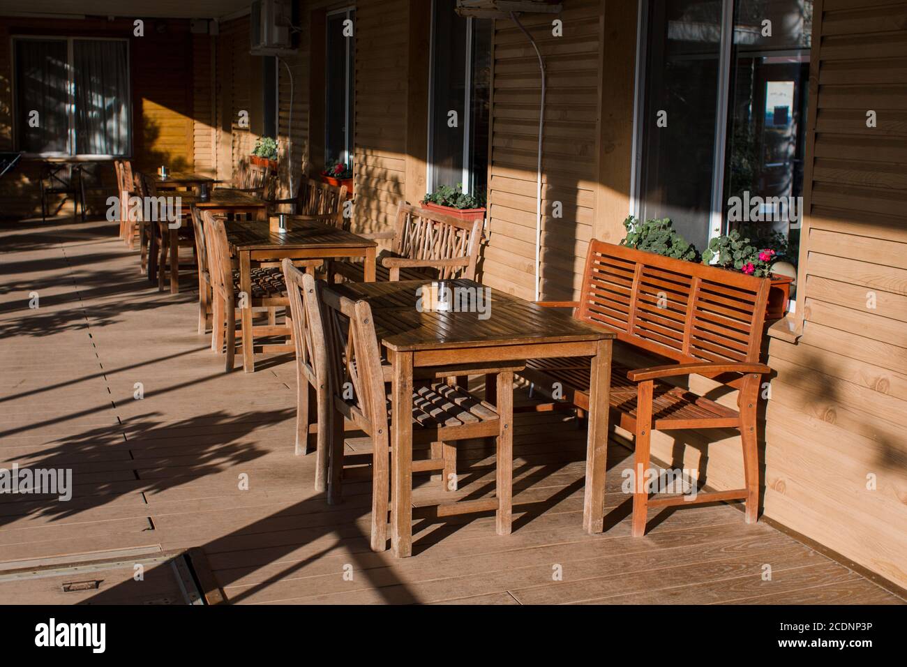 wooden tables in restaurant on the street Stock Photo - Alamy