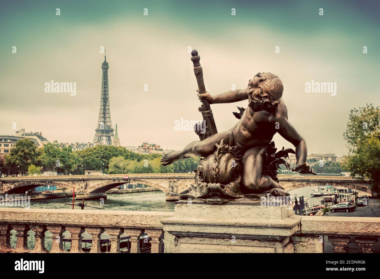 Statue on Pont Alexandre III bridge in Paris, France. Seine river and ...