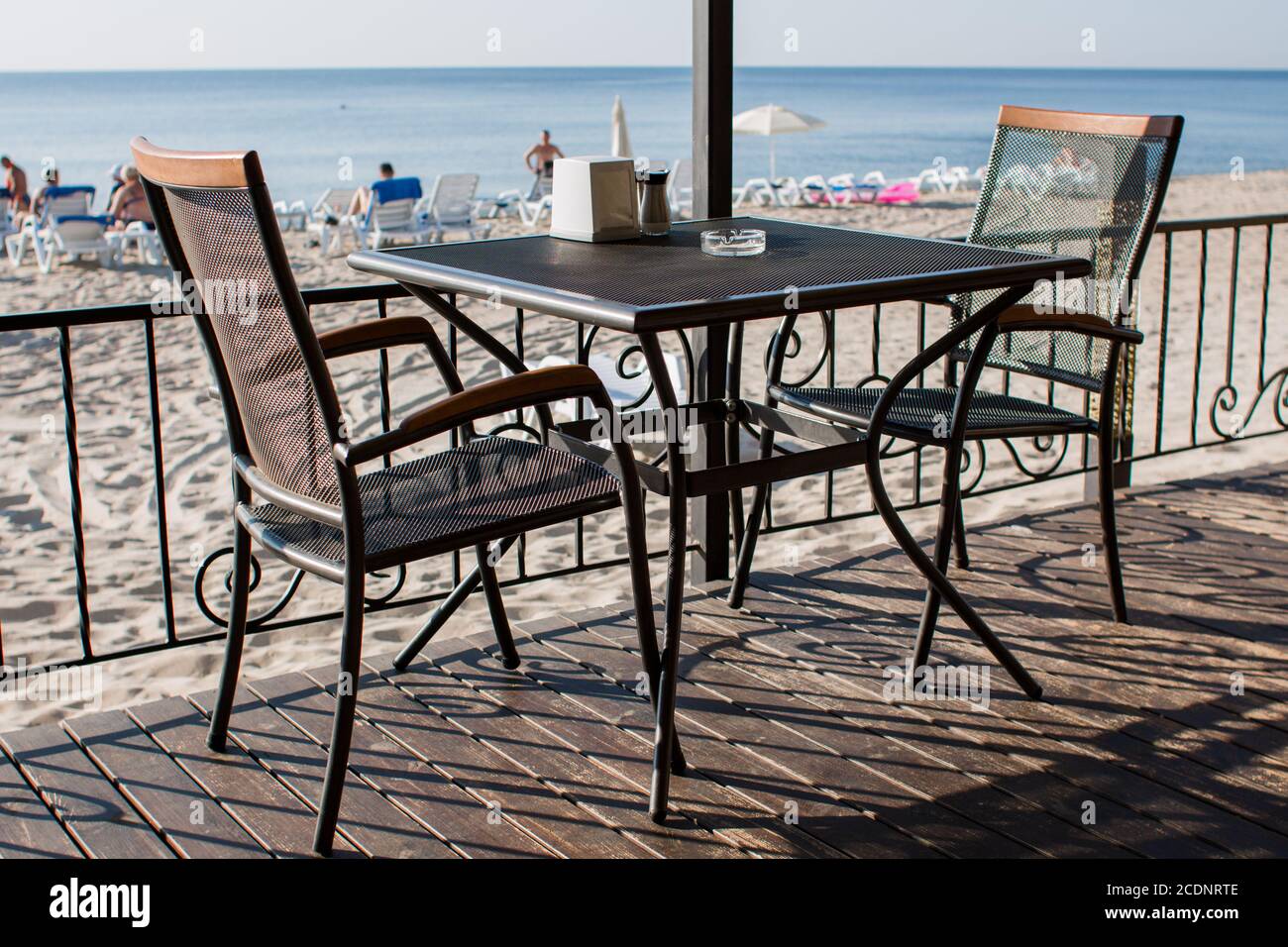 restaurant tables on the terrace near beach Stock Photo - Alamy