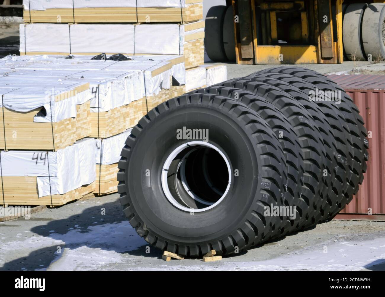 Big machines tires stack background Stock Photo - Alamy