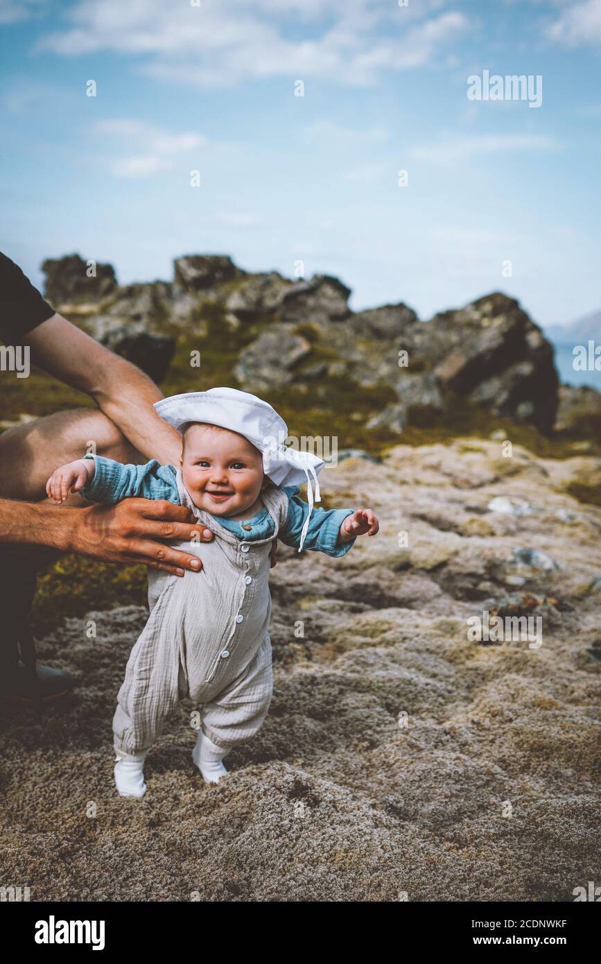 Child girl walking on moss outdoor with father family travel in Norway ...