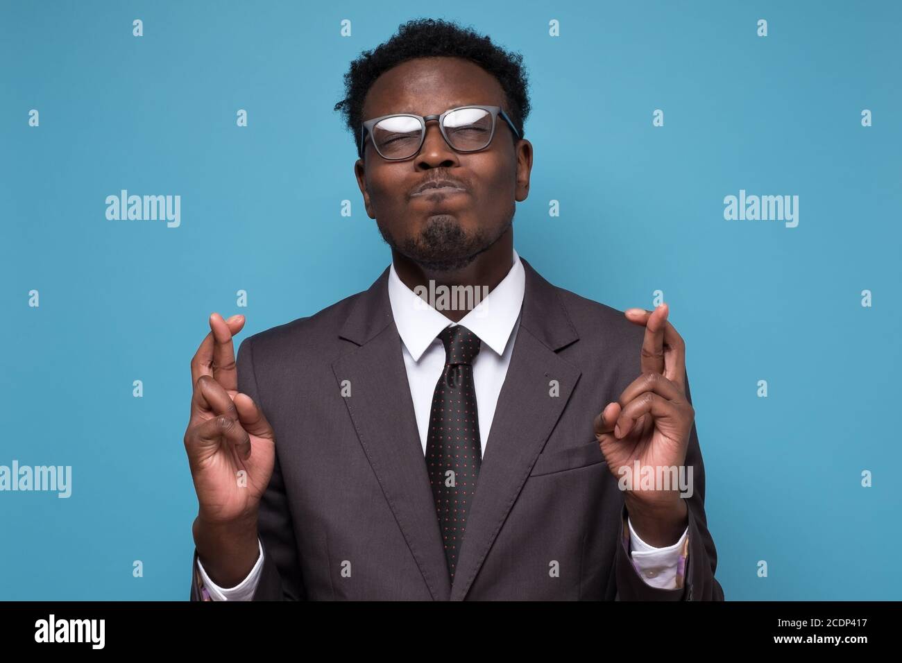 African young businessman making a wish crossing fingers Stock Photo ...