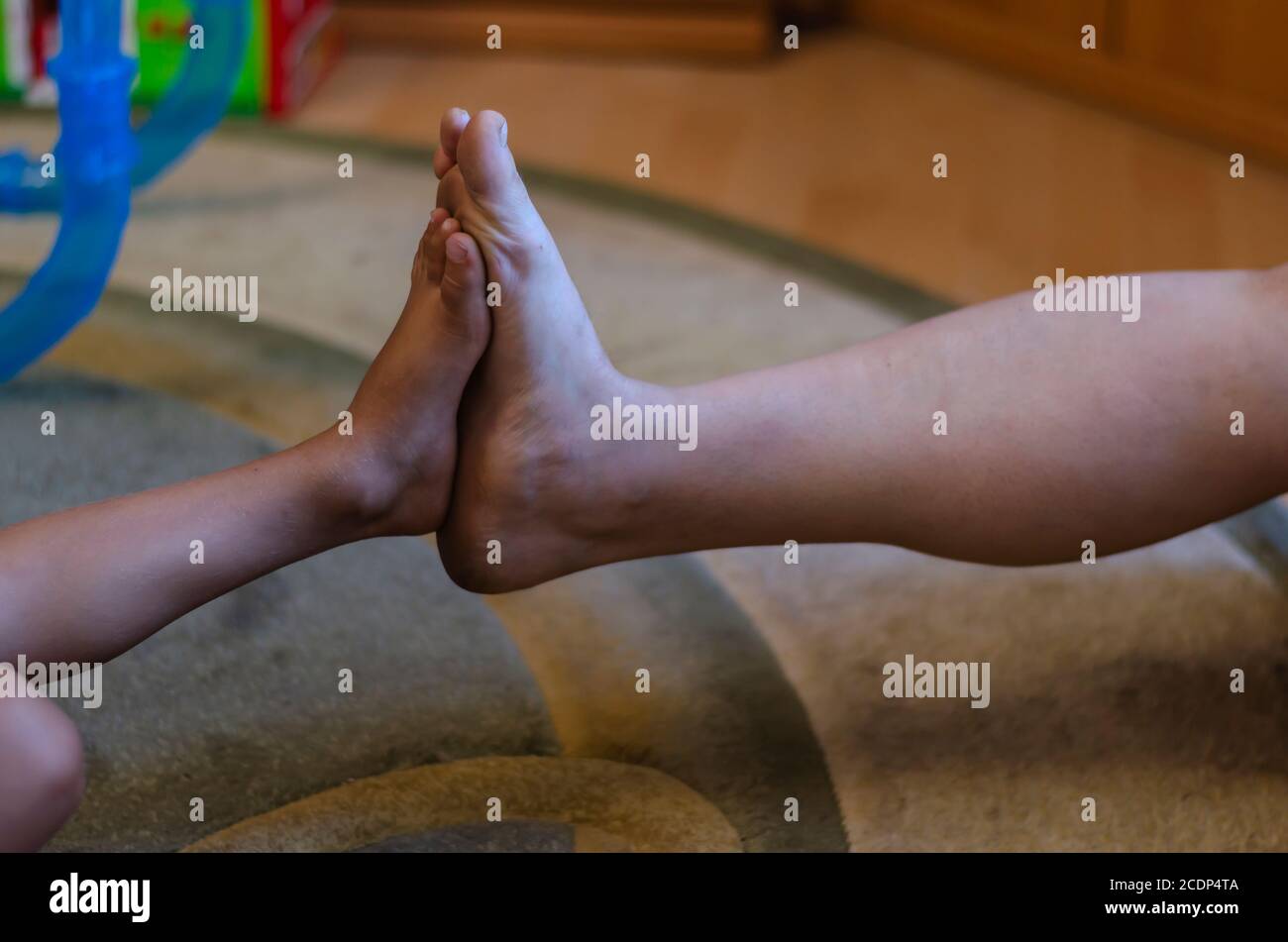 Touching the feet of an adult woman and a preschool boy. The child and ...