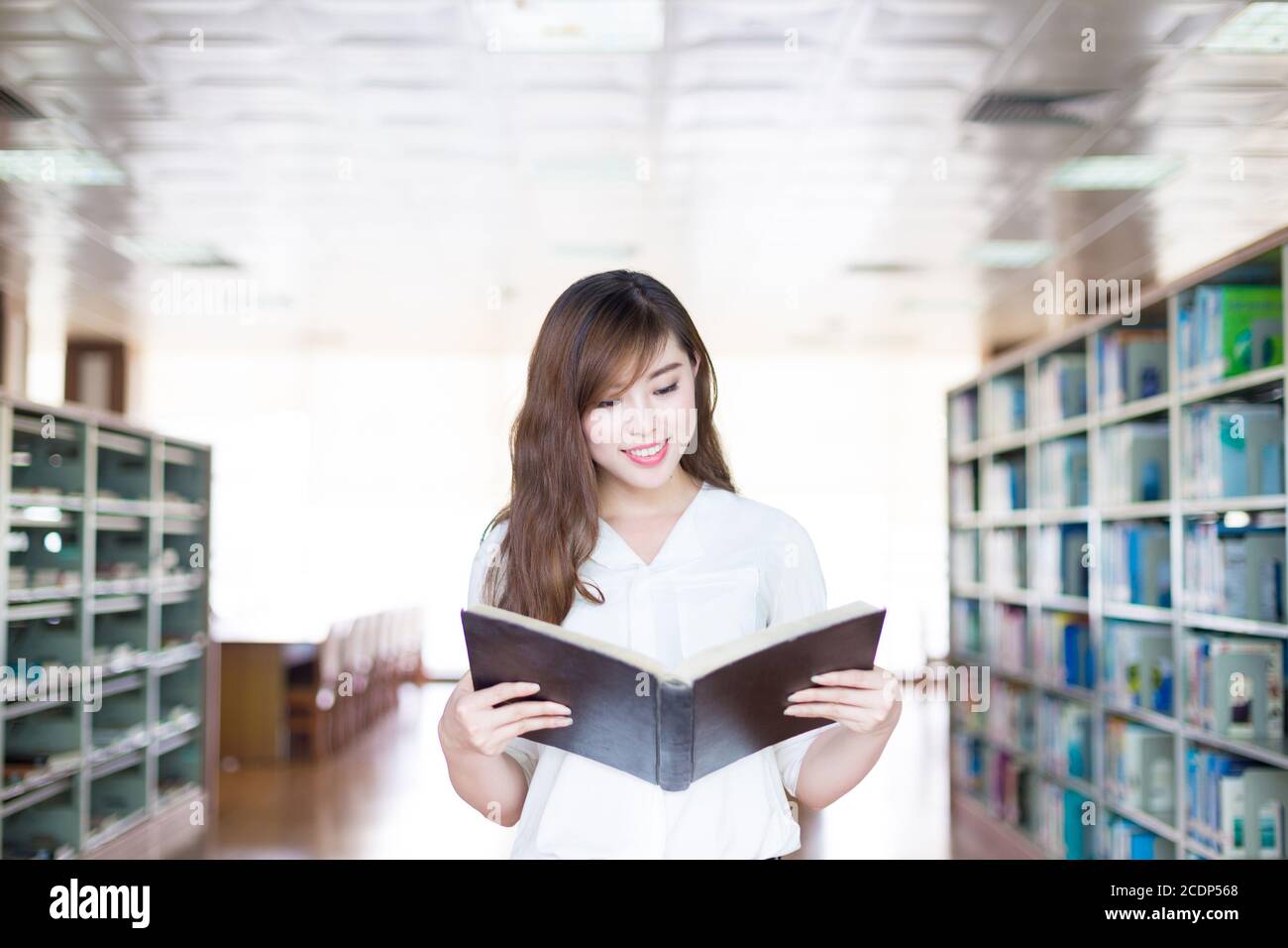 young beautiful asian girl student in library Stock Photo - Alamy
