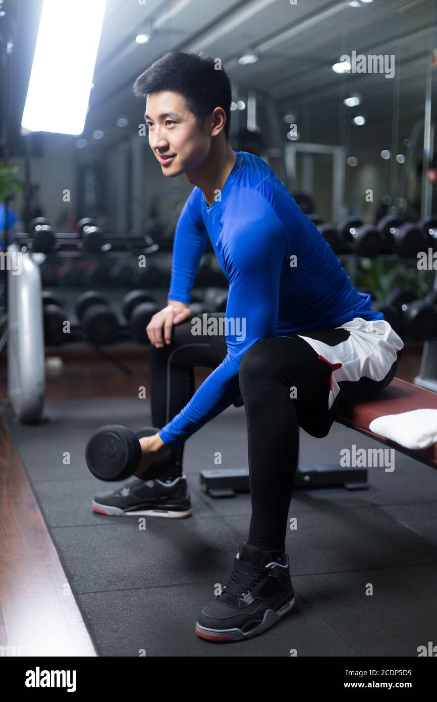 young asian man working out in modern gym Stock Photo - Alamy