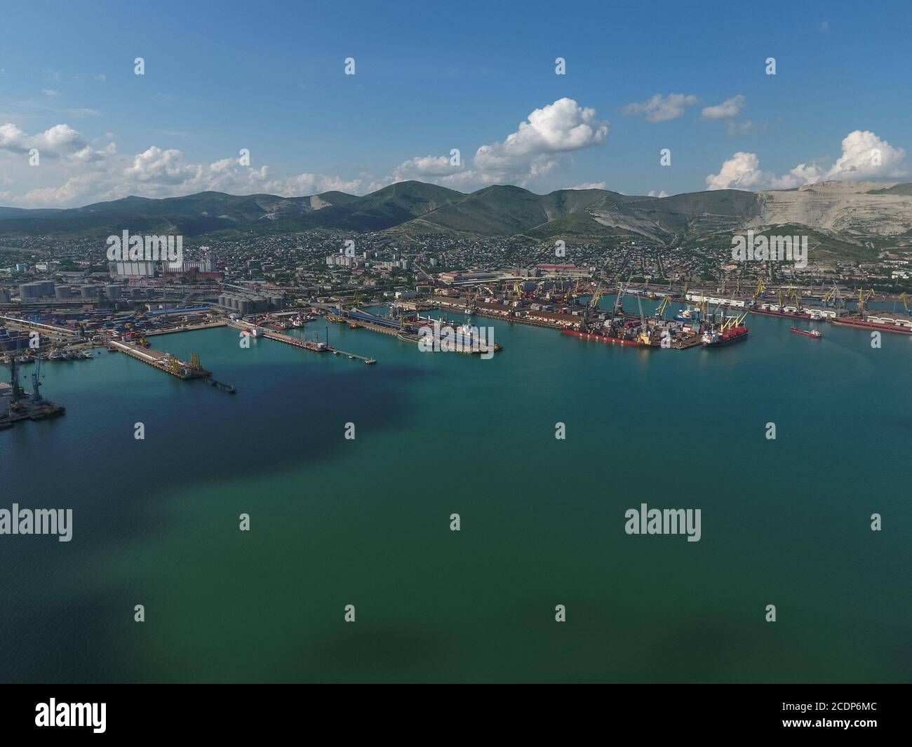 Industrial seaport, top view. Port cranes and cargo ships and barges ...