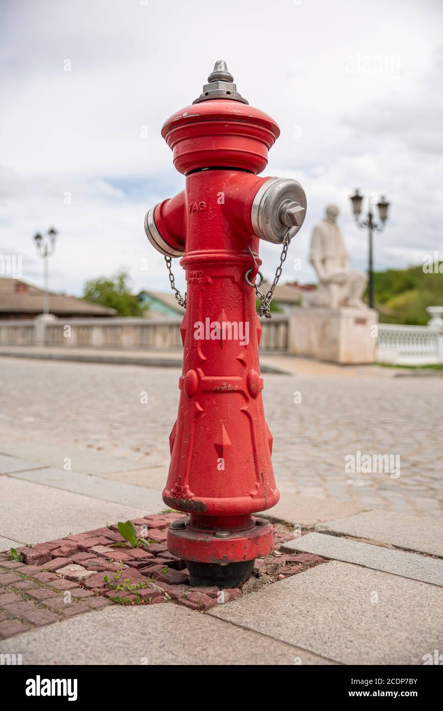 Single red fire hydrant standing on the pavement. Fire hidrant for ...