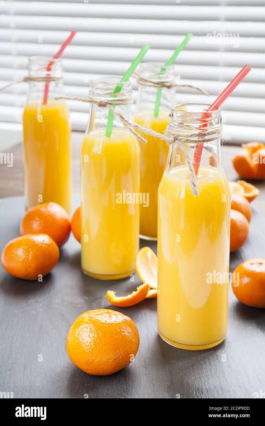 Natural and fresh orange juice in small bottles with fresh orange Stock ...