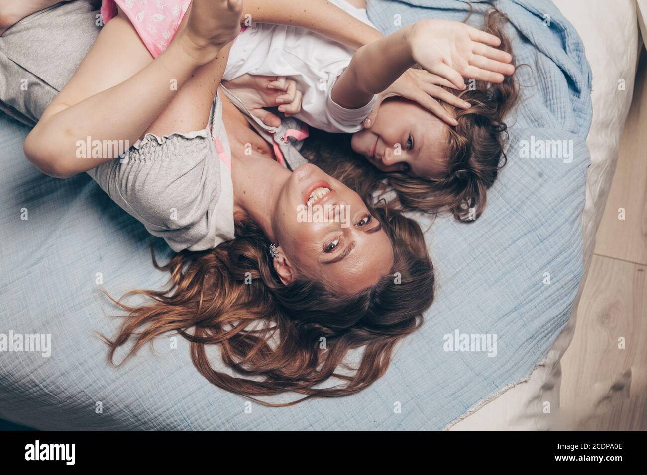 Happy loving family lying relaxing and enjoying in bedroom together ...