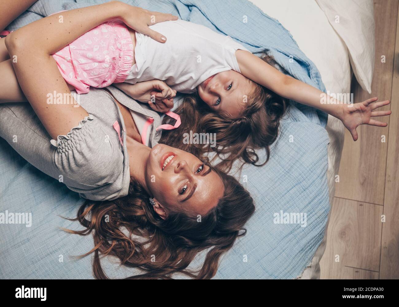 Happy loving family lying relaxing and enjoying in bedroom together ...