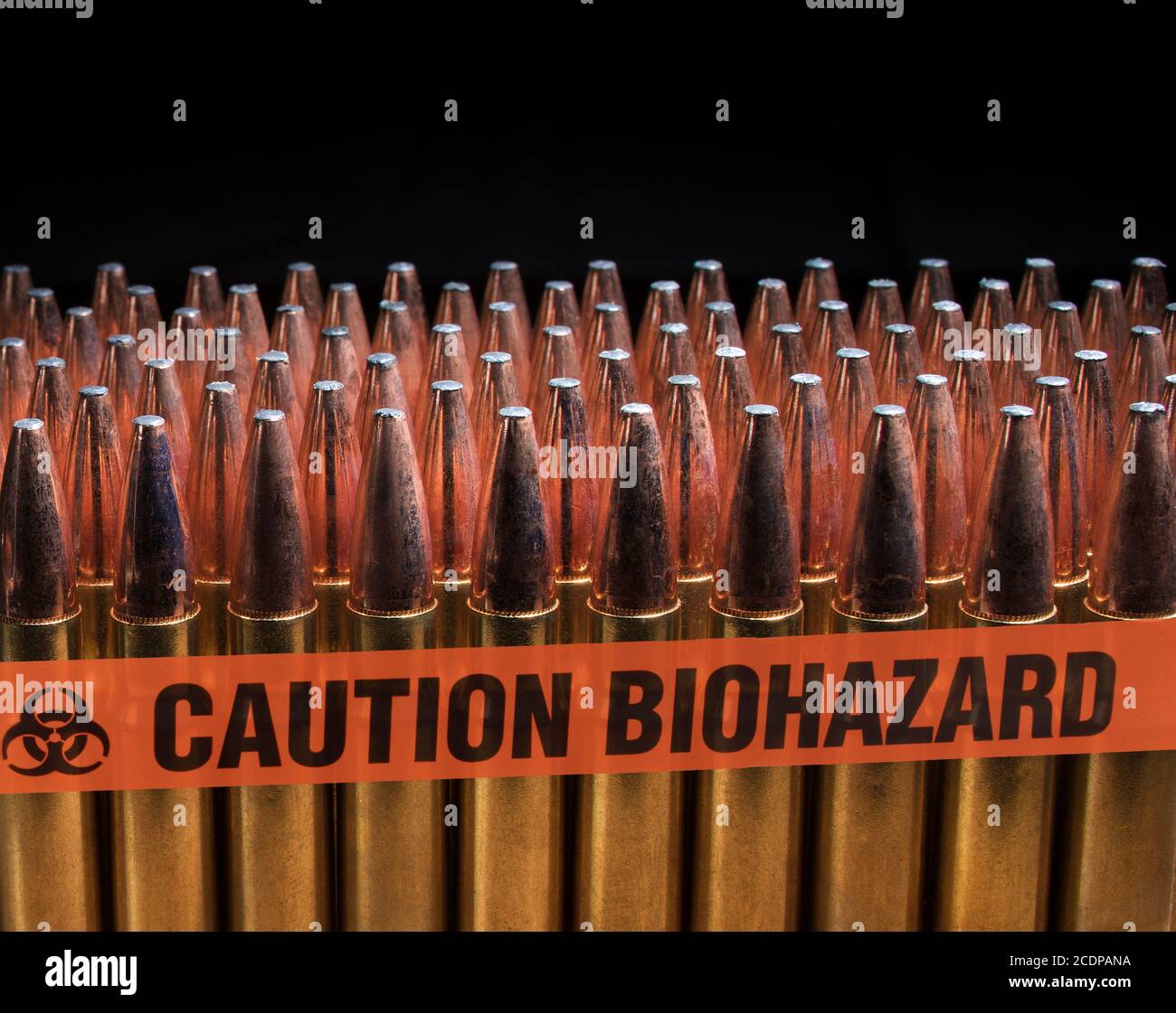 Line of rifle cartridges with biohazard tape in front and room on top ...
