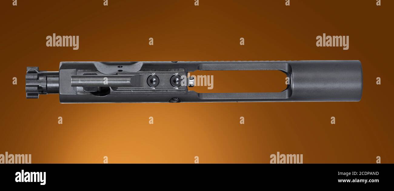 Bolt carrier group for an assault rifle on a brown background Stock ...