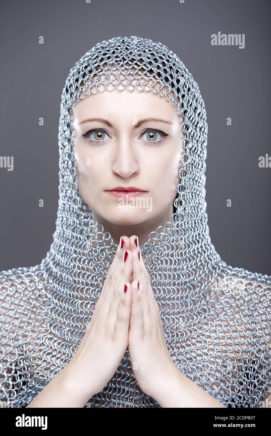 Young woman with medieval Chainmail Hood with hands folded Stock Photo ...