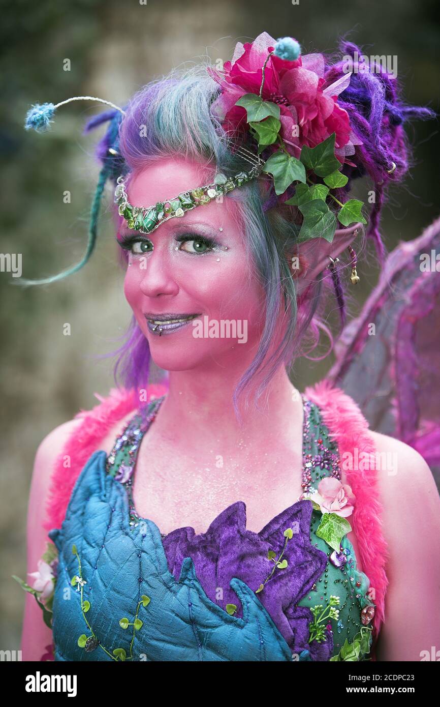Young smiling woman in a colorful elf costume Stock Photo - Alamy