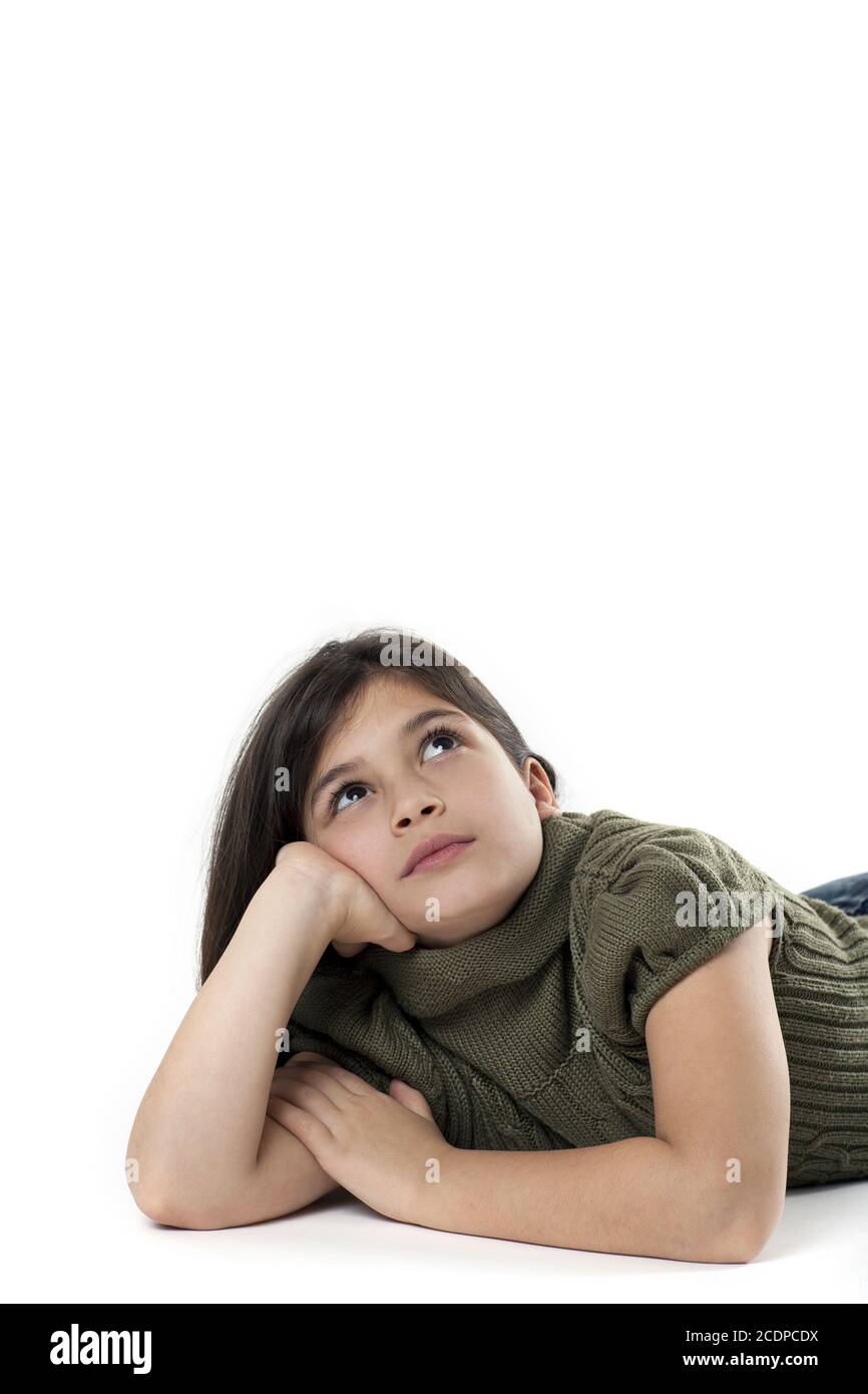 Young girl lying on the ground with a thoughtful look upwards Stock ...