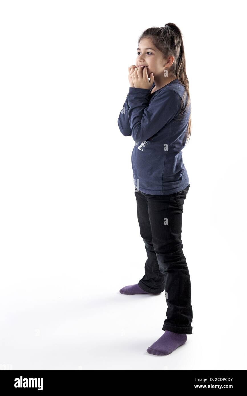 Excited looking young girl in front of a white background Stock Photo ...