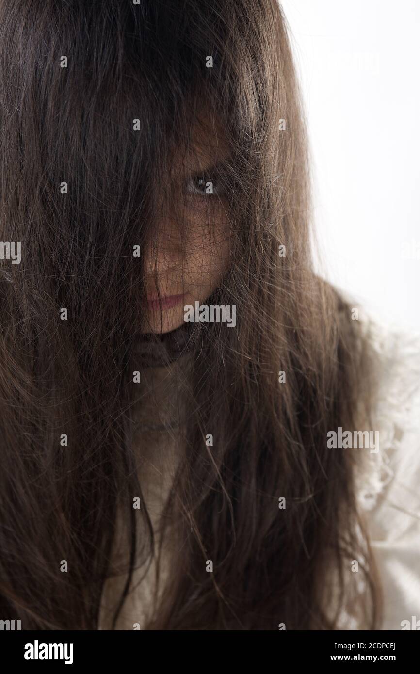 Evil looking young girl in a historical dress Stock Photo - Alamy