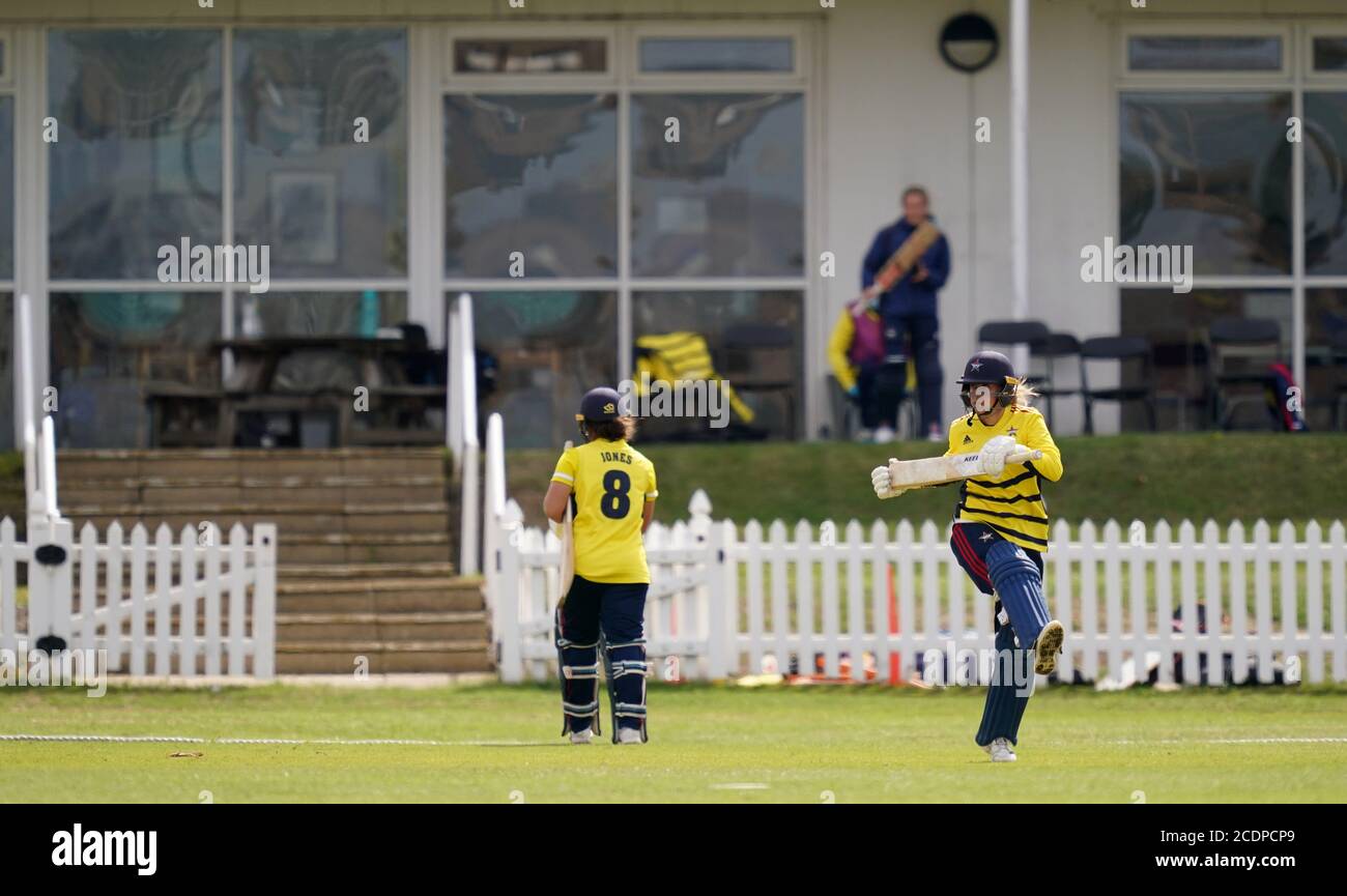 South East Star's Tash Farrant (right) walks out to bat during the ...