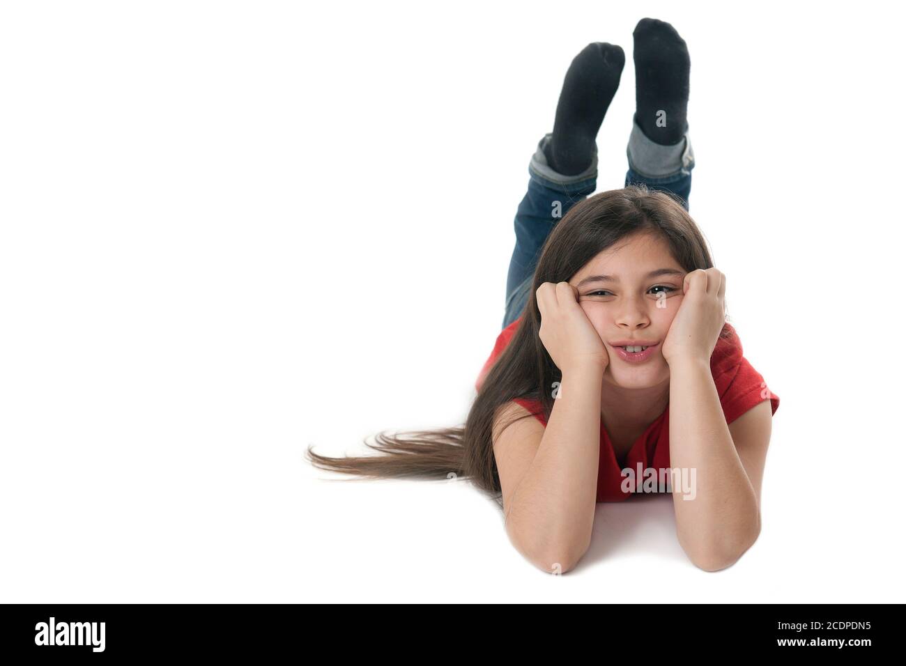 Bored looking young girl lying on the ground Stock Photo - Alamy