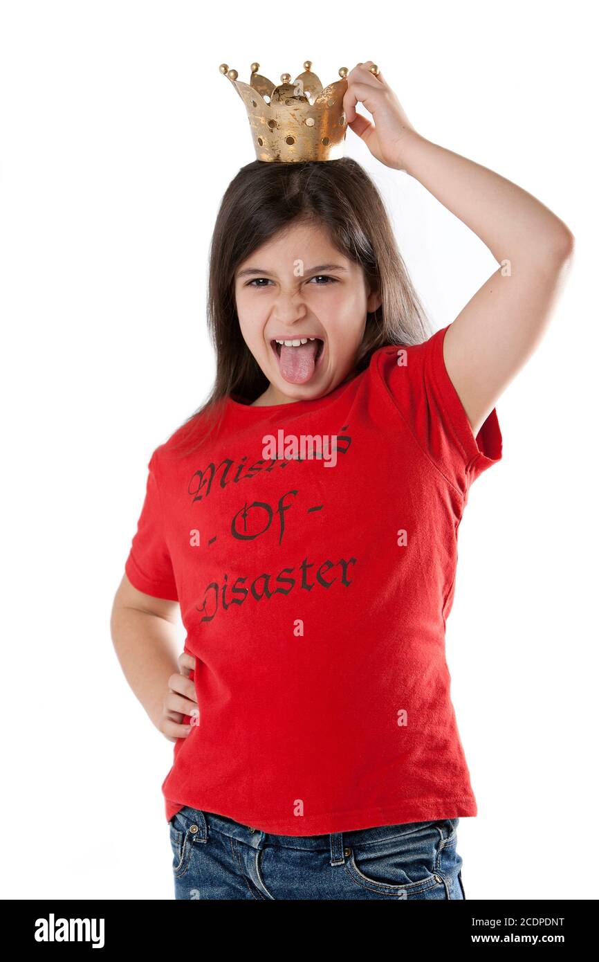 Cheeky looking young girl in a red T-shirt with cheeky slogan and ...