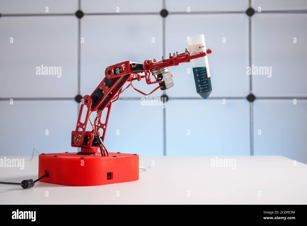 Robot arm with test tube with biological sample in science laboratory ...