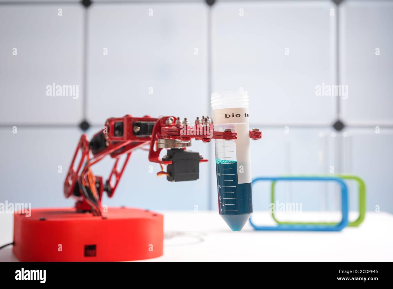 Robot arm with test tube with biological sample in science laboratory ...