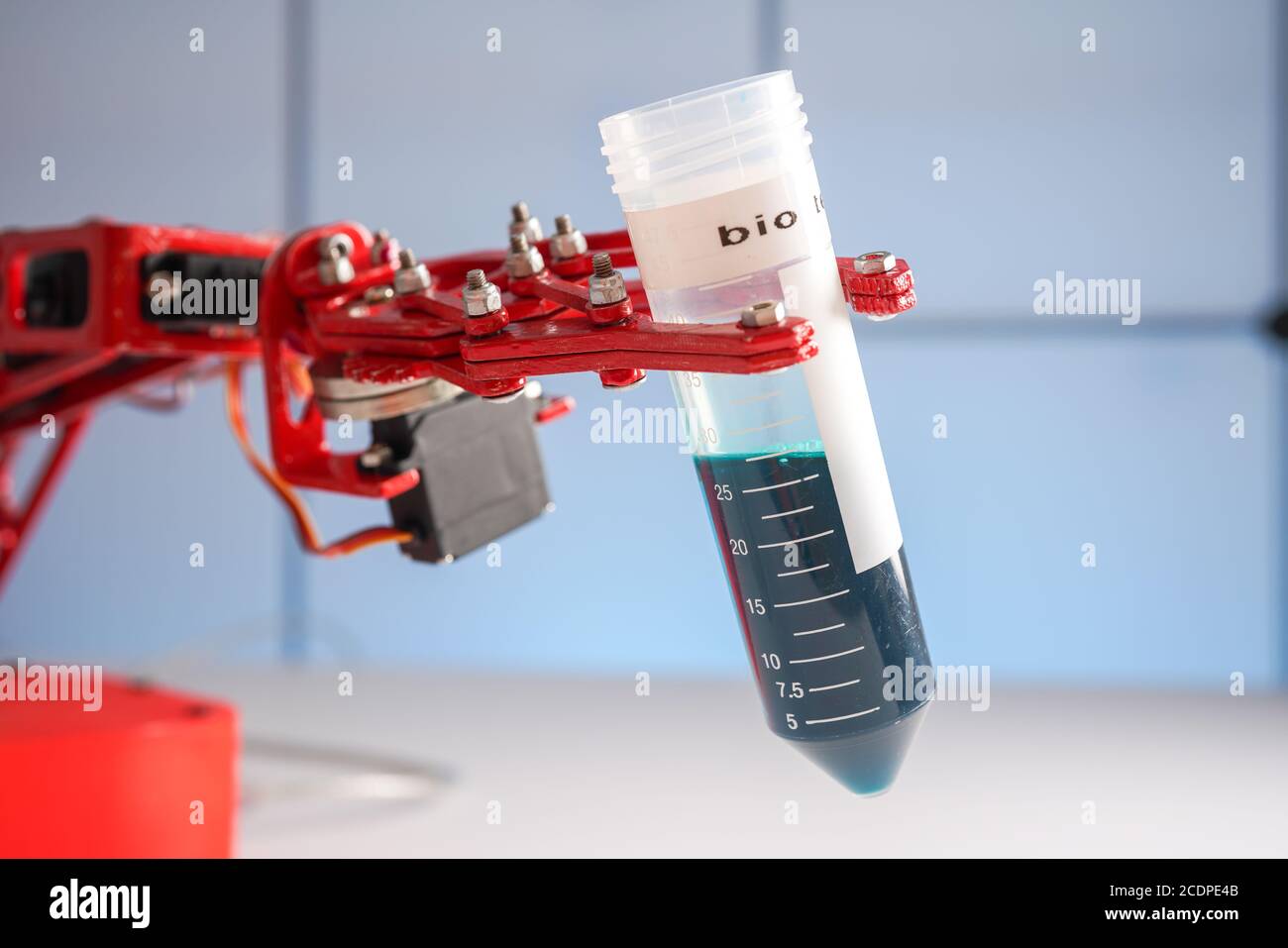 Robot arm with test tube with biological sample in science laboratory ...