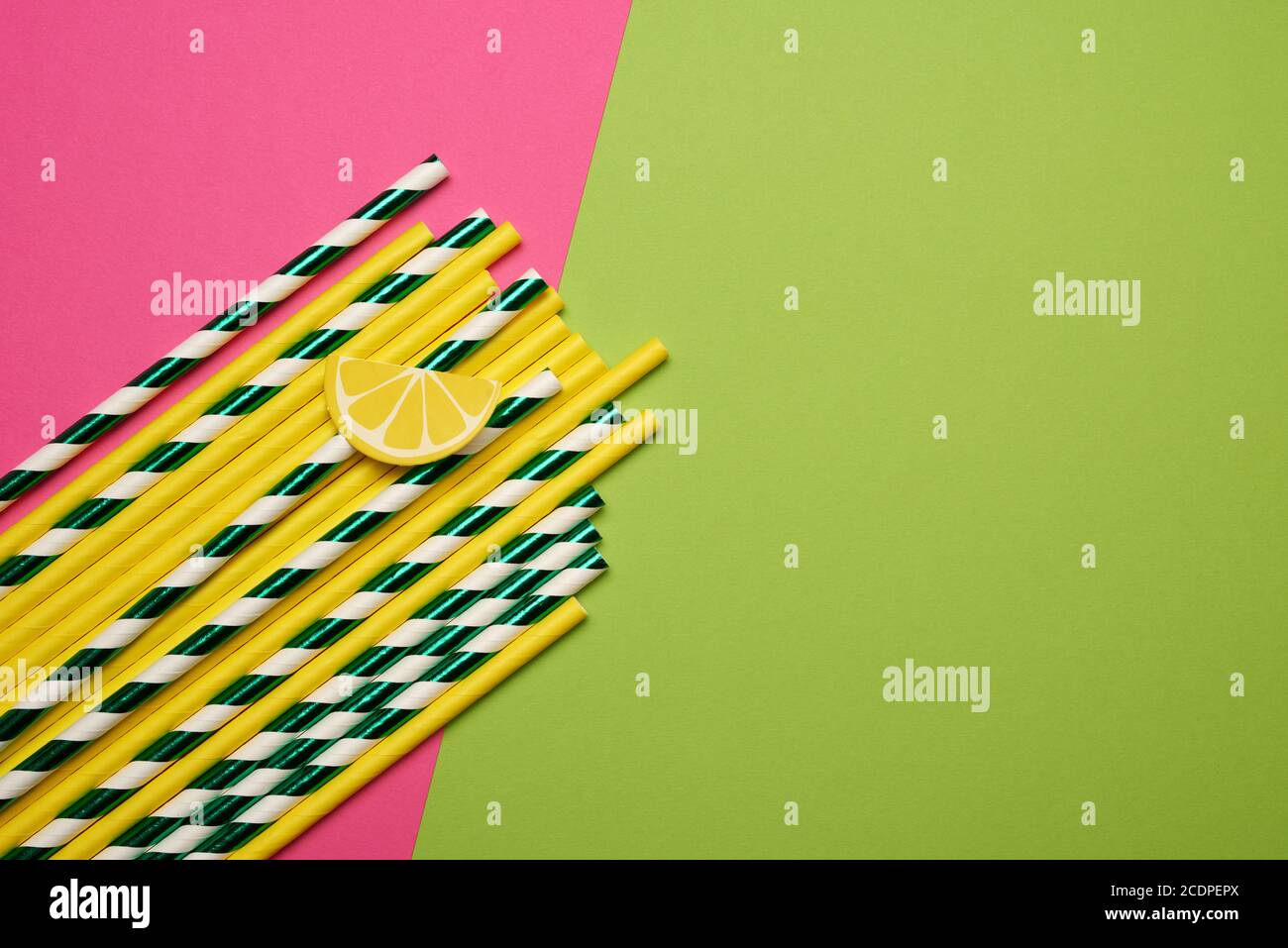 paper multicolored cocktail tubes on pink green background, rejection ...