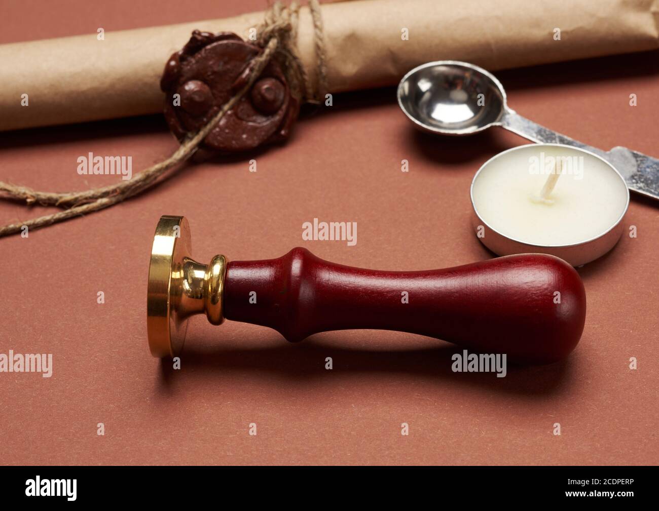 metal stamp on wooden handle for sealing envelope, candle and brown ...