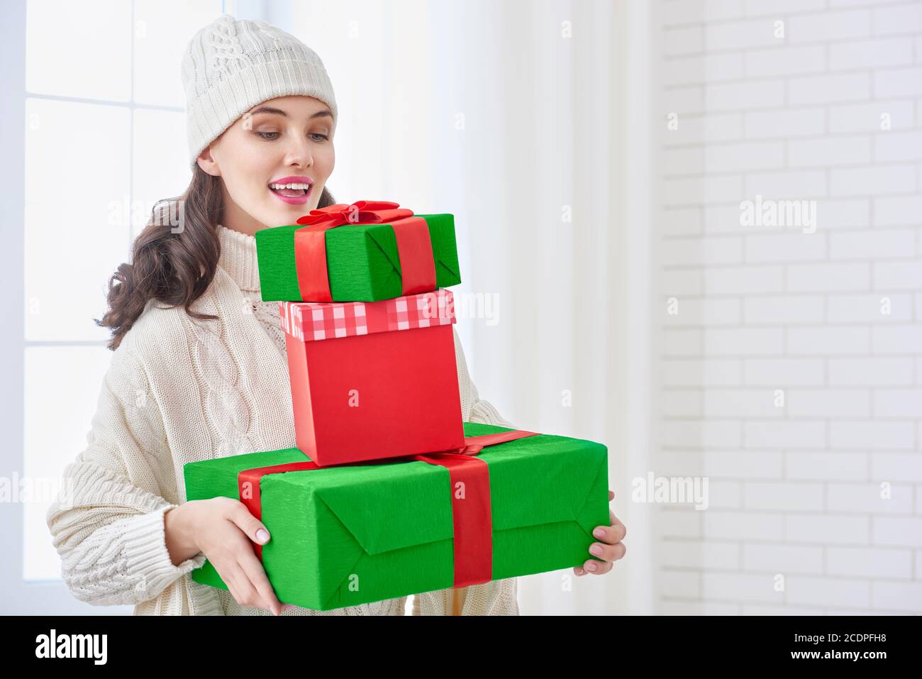 Beautiful young woman with gift boxes Stock Photo - Alamy