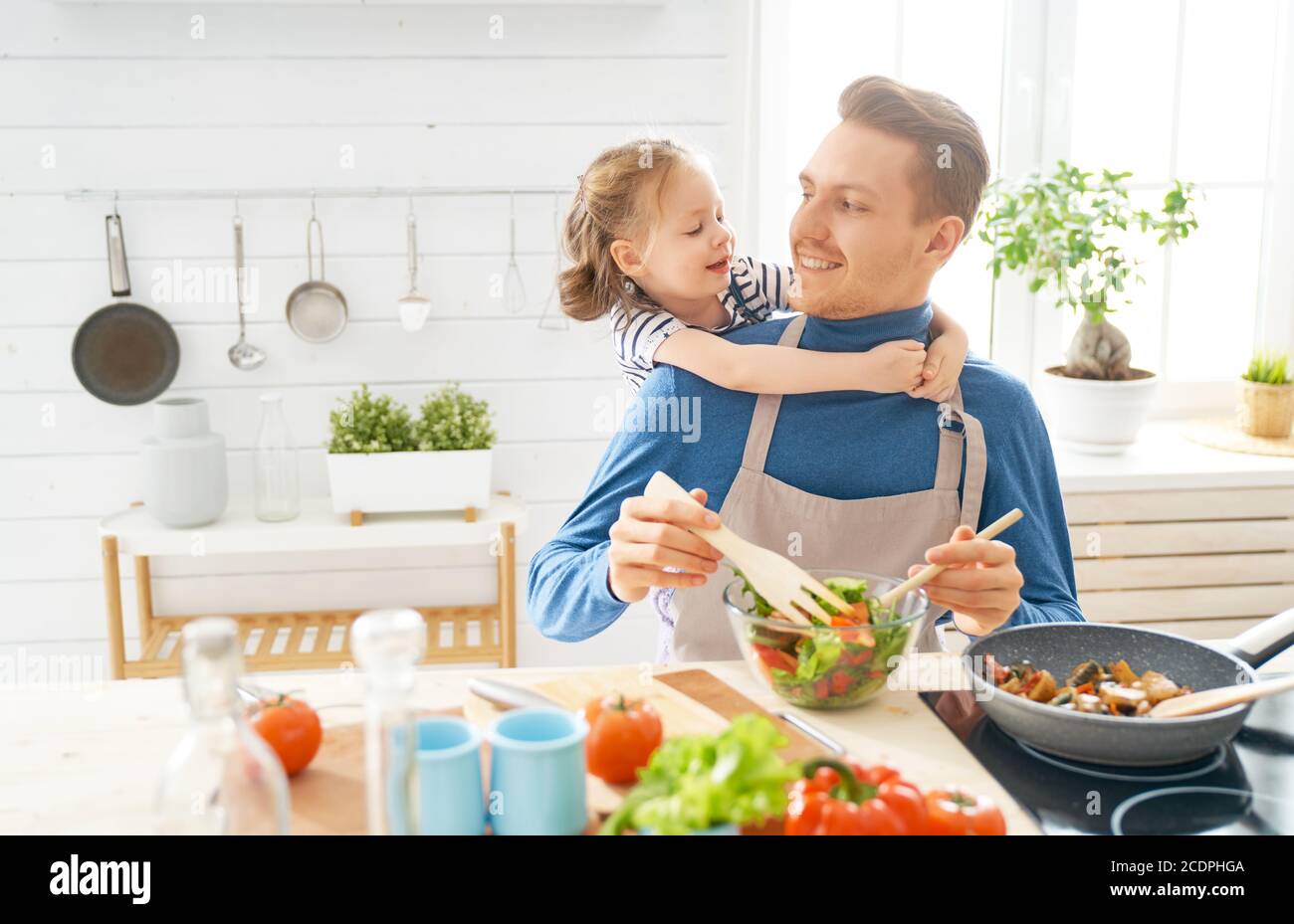 Healthy food at home. Happy family in the kitchen. Father and child ...
