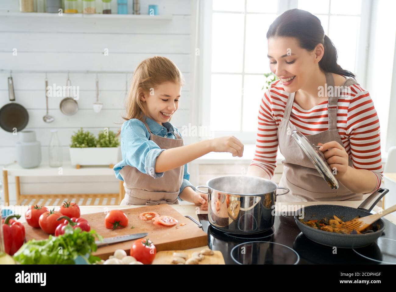 Healthy food at home. Happy family in the kitchen. Mother and child ...