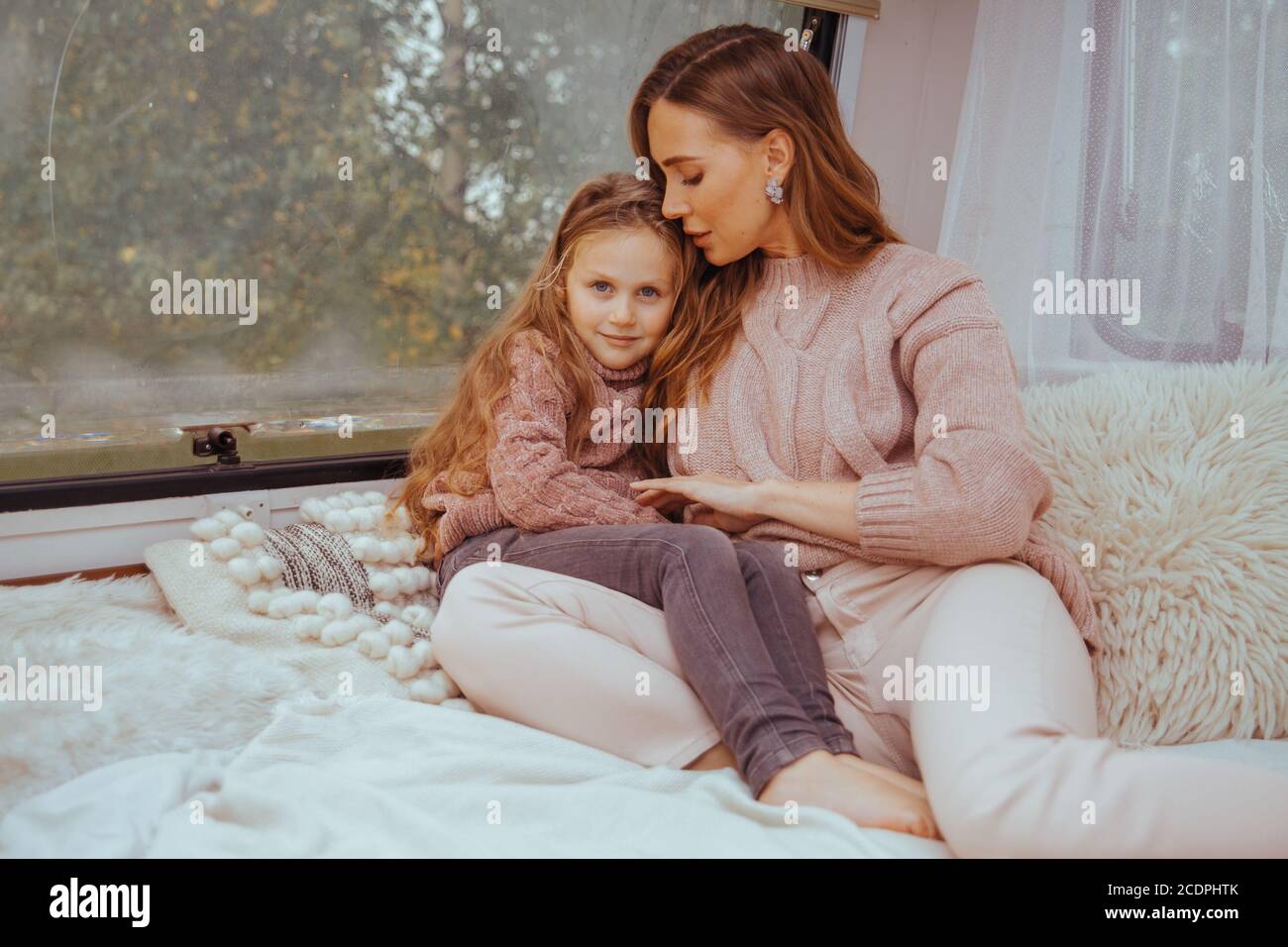 Happy family - mother and little daughter relaxing hugging and having ...