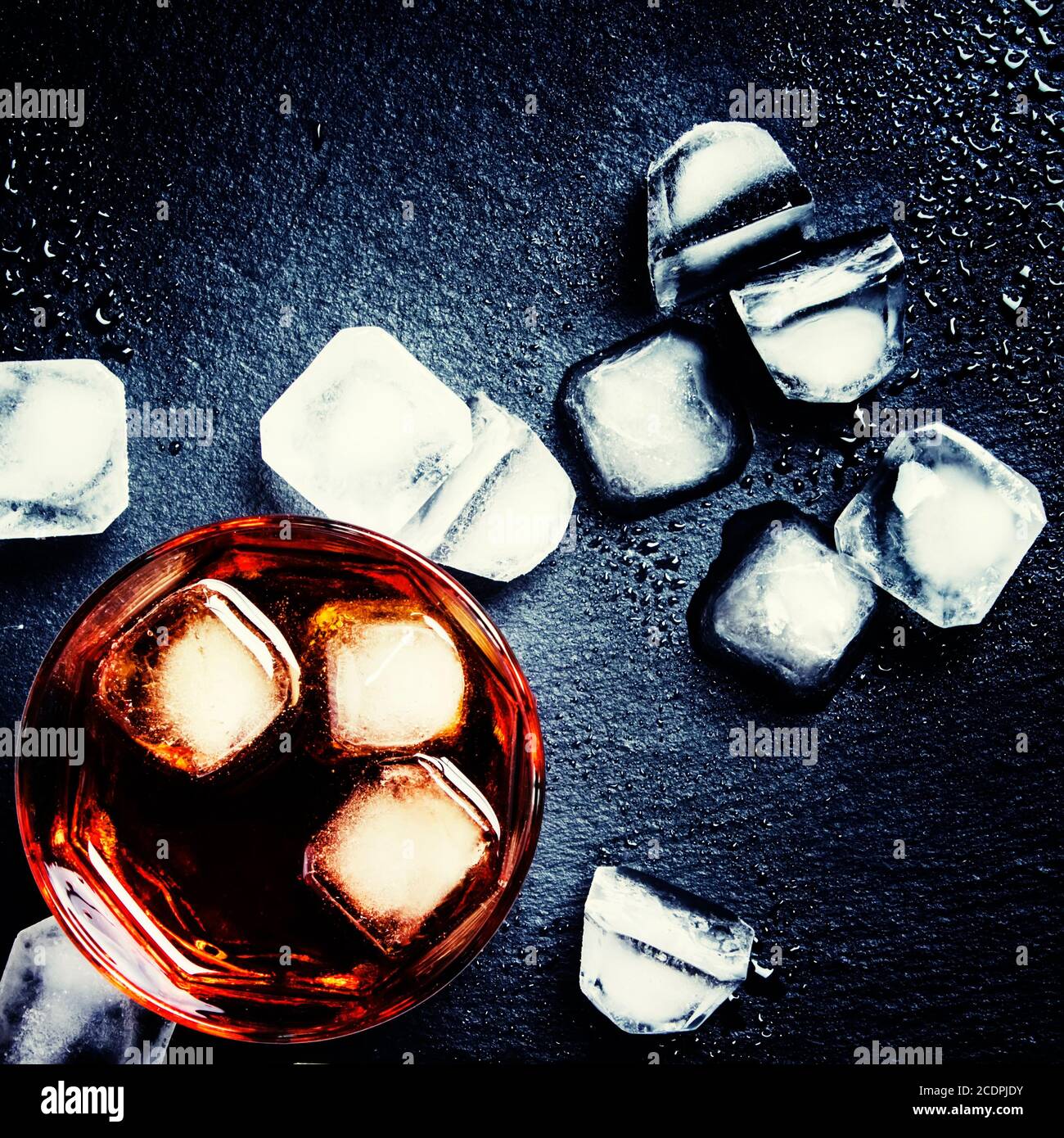 Cold whiskey with ice, black background, low key, top view Stock Photo ...