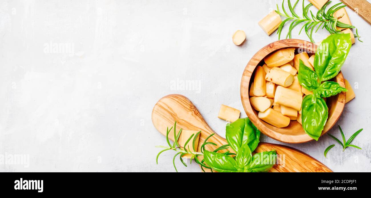 Traditional smoked Chechil cheese in bowl and cutting board, top view ...