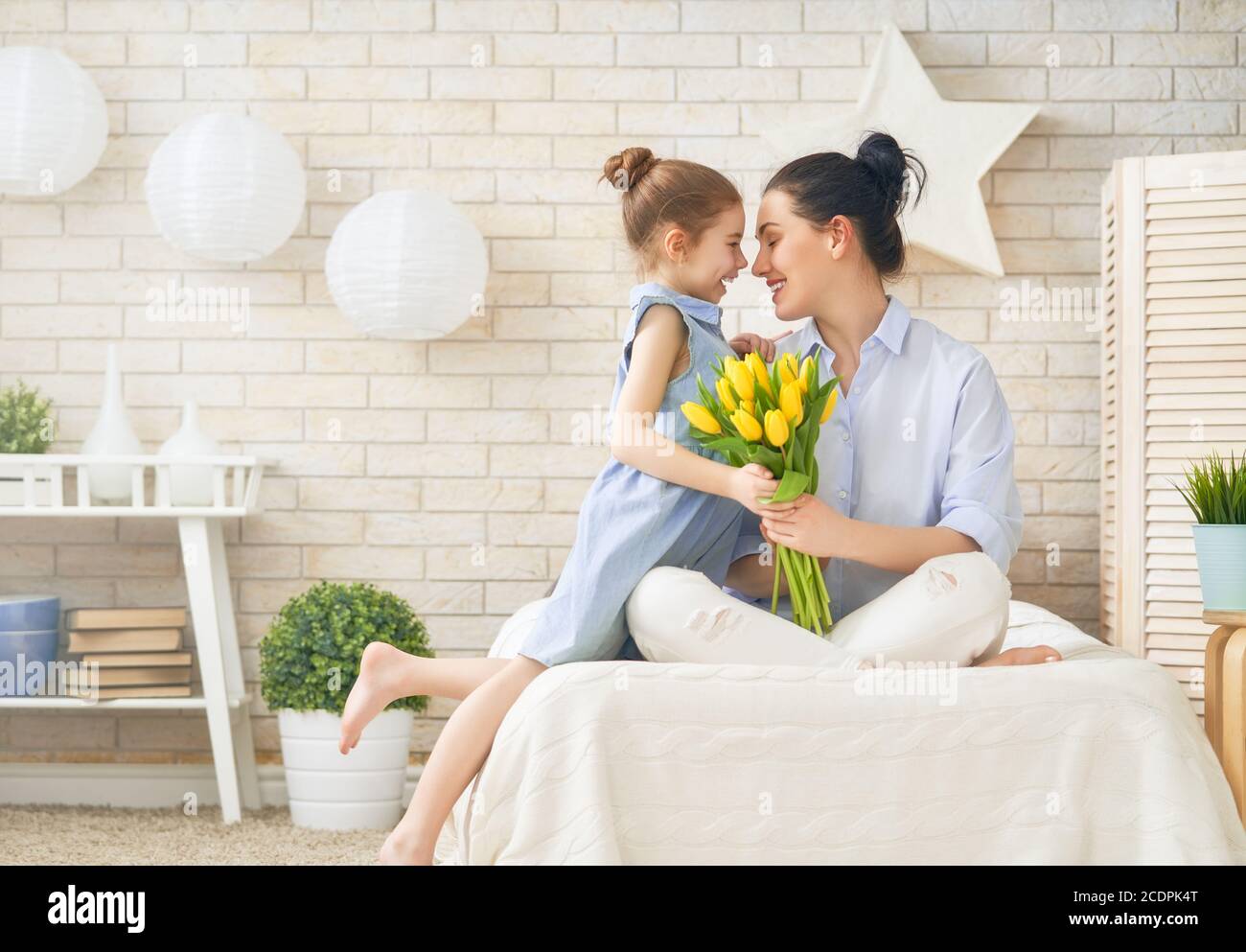 Happy mother's day! Child daughter is congratulating mom and giving her ...