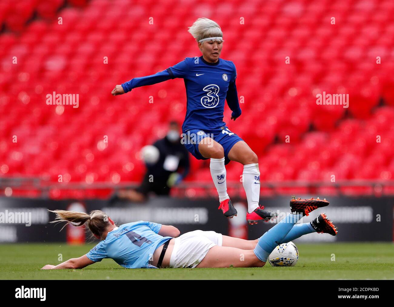 Chelsea's Ji So-Yun jumps over a challenge from Manchester City's Gemma ...