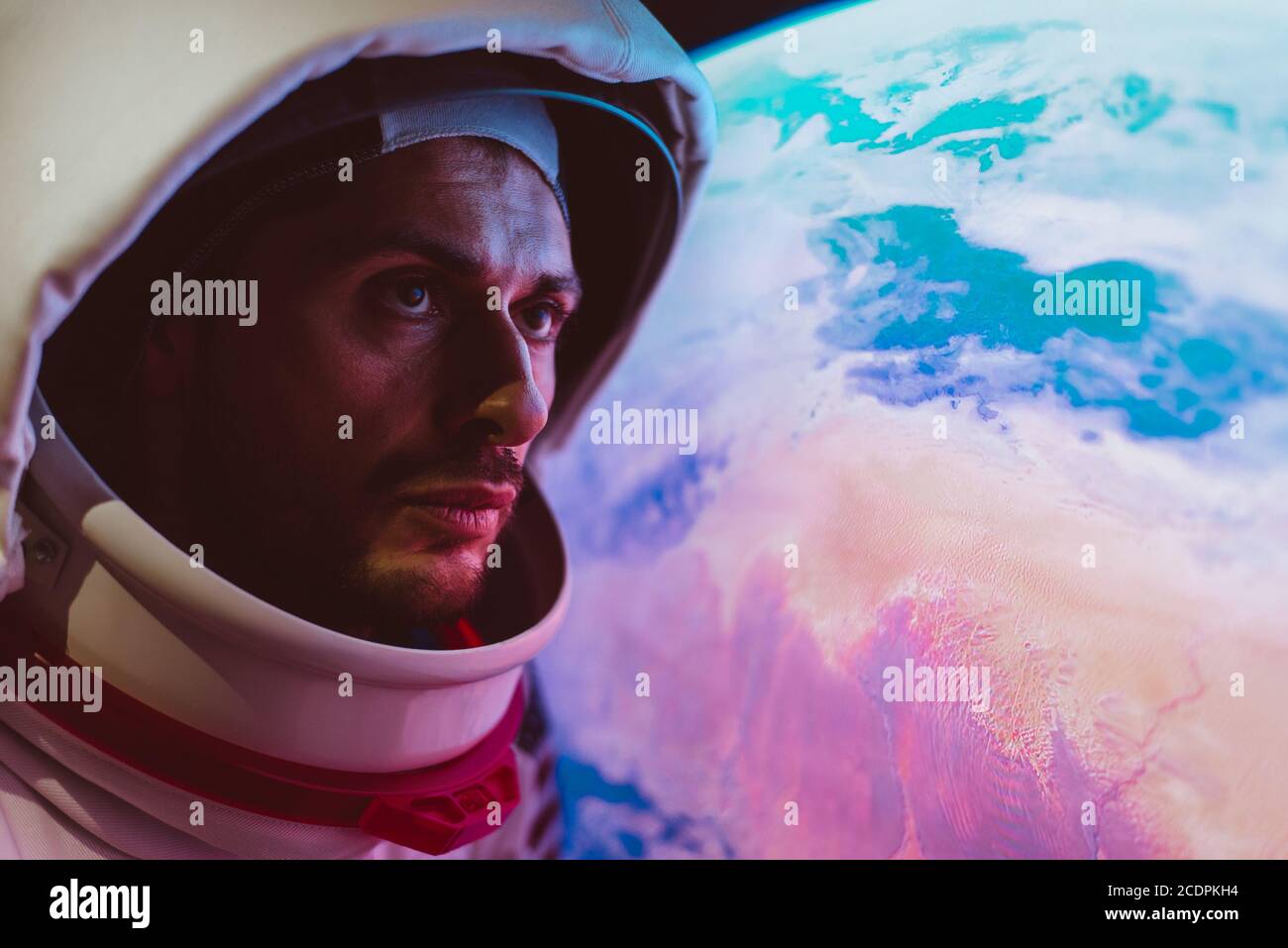 Astronaut looking planet earth from the window of his capsule. Concept ...