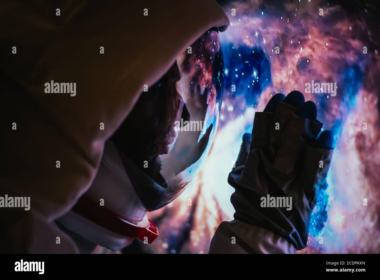 Astronaut looking deep space, galaxy and planets from the window of his ...