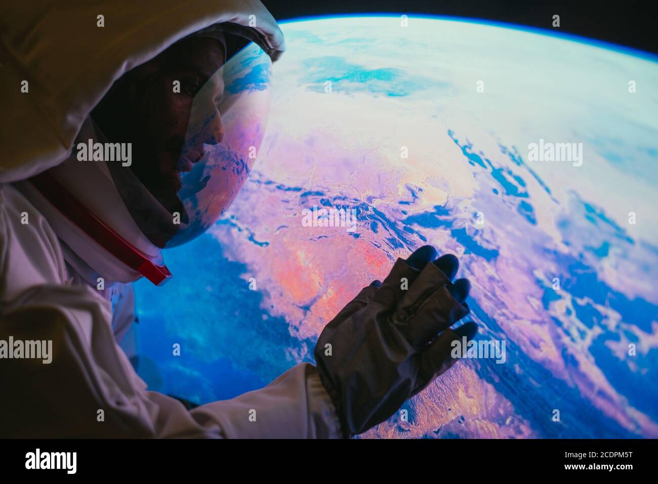 Astronaut looking planet earth from the window of his capsule. Concept ...
