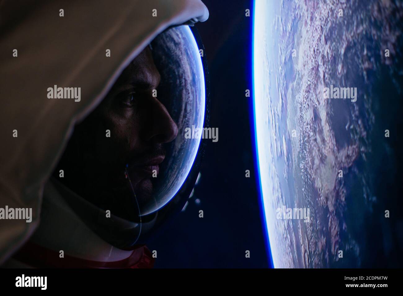 Astronaut looking deep space, galaxy and planets from the window of his ...