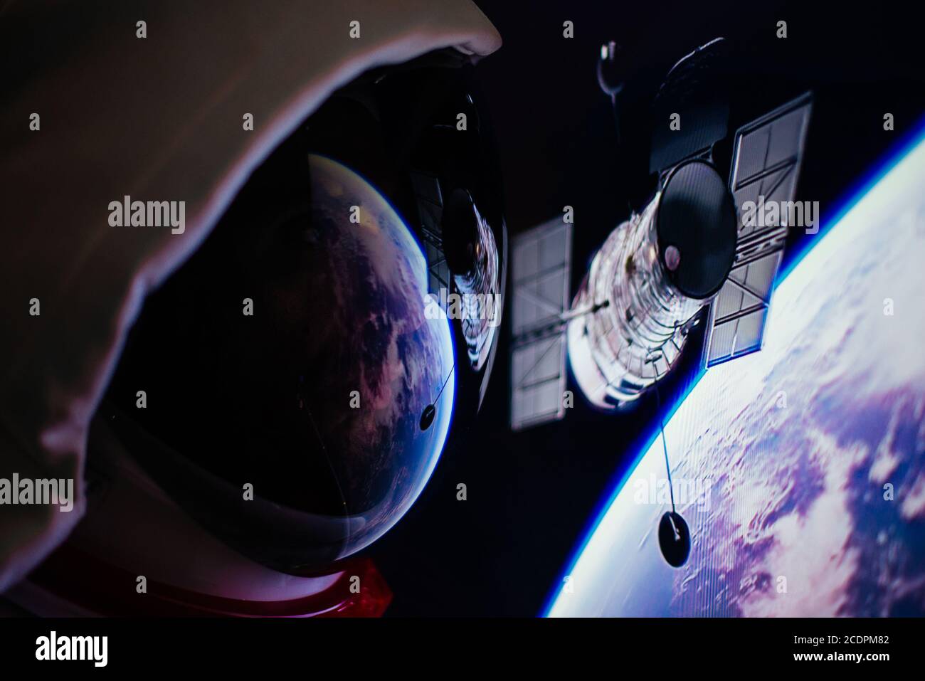 Astronaut looking deep space, galaxy and planets from the window of his ...